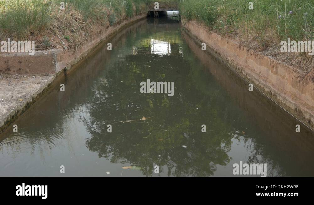 4K Ditch stream river water dirty acequia irrigation canal flowing ...