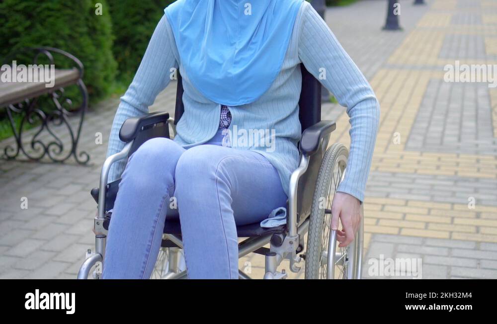 positive young disabled woman in wheelchair Muslim hijab smiling ...