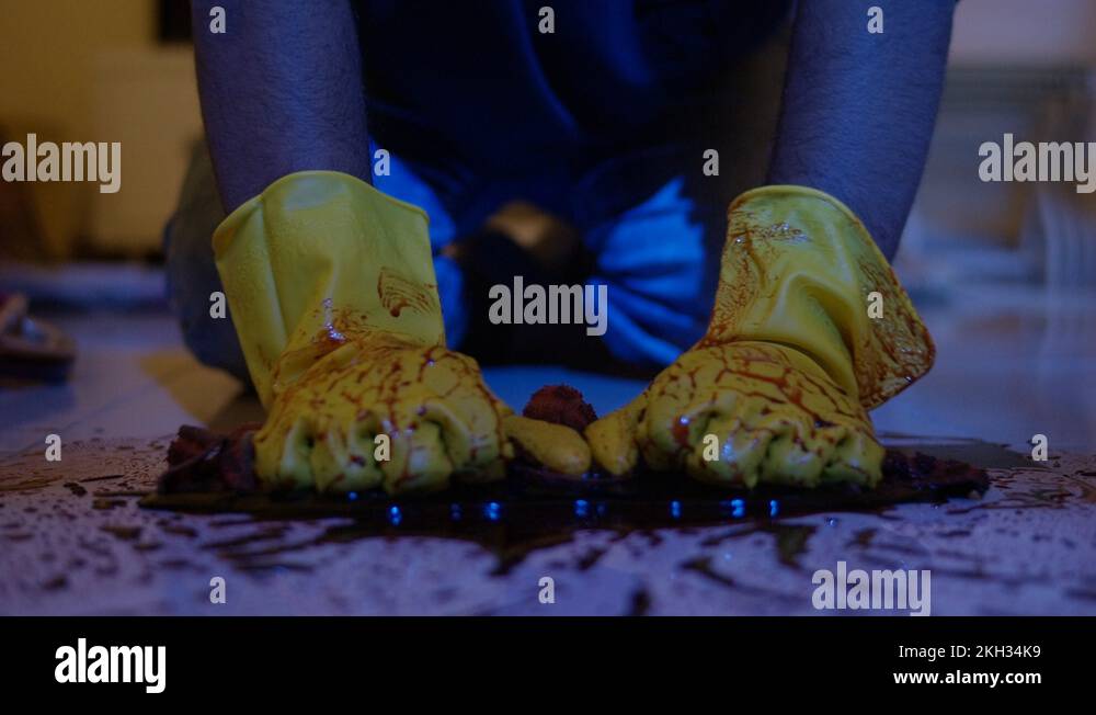 The unrecognizable killer cleaning blood on the scene of a murder ...