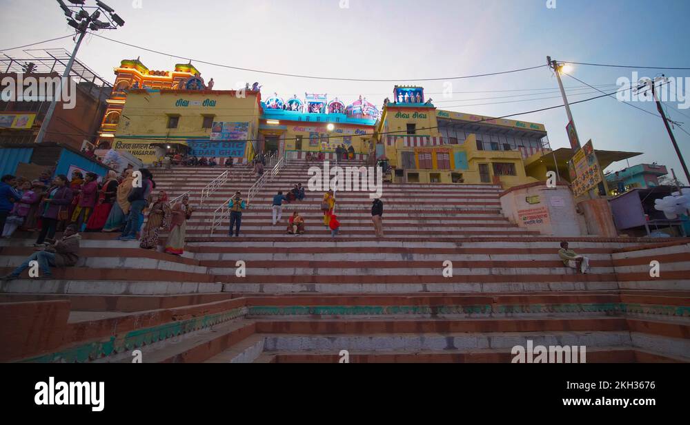 People resting on stairs of Hindu temple on Ganges river bank, Varanasi ...