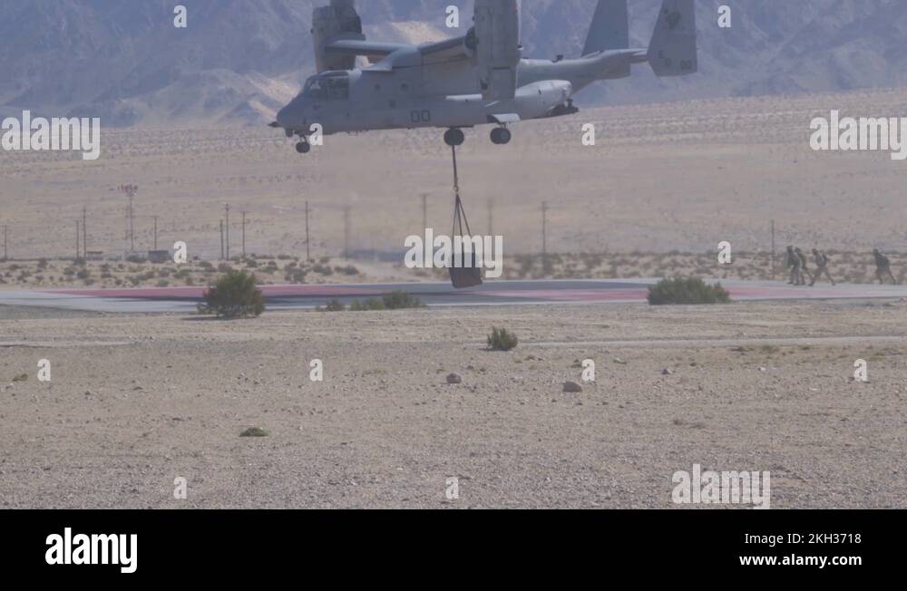 MV-22 Osprey lifting sling load from airfield in desert Stock Video ...