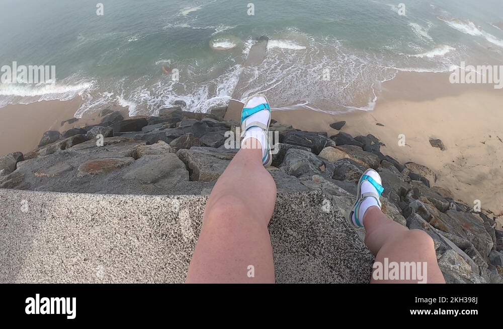Female legs with a view of the Atlantic Ocean. Empty beach in Povoa de ...
