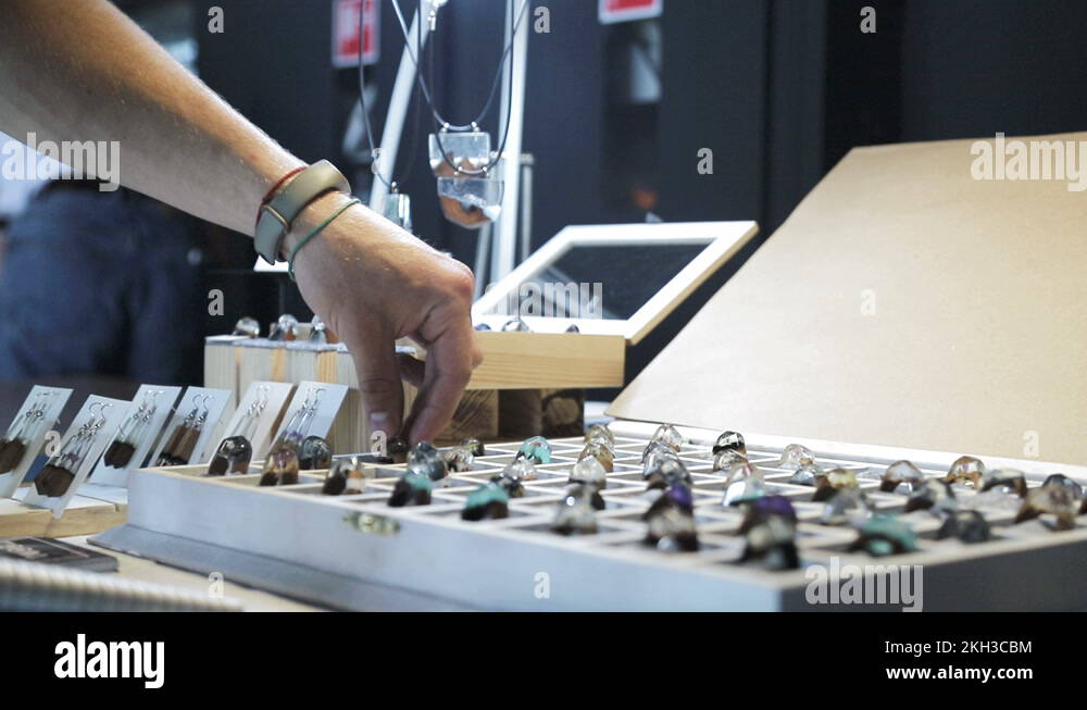 Jeweler using a measuring stick, measures the size of the rings of ...