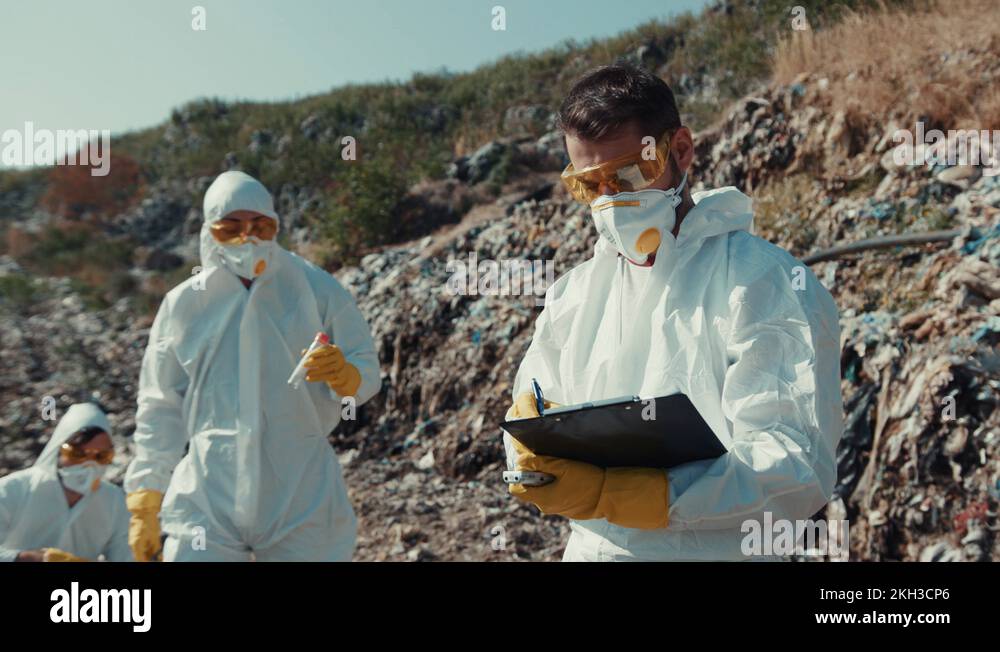Biological hazard. Scientists team analyzing pollution on waste dump ...