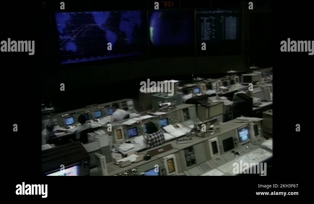 1990s: Woman engineer in NASA control room. Bead of water manipulated ...