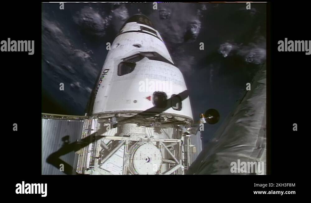 1990s: Space shuttle in orbit. Robotic arm releases satellite ...