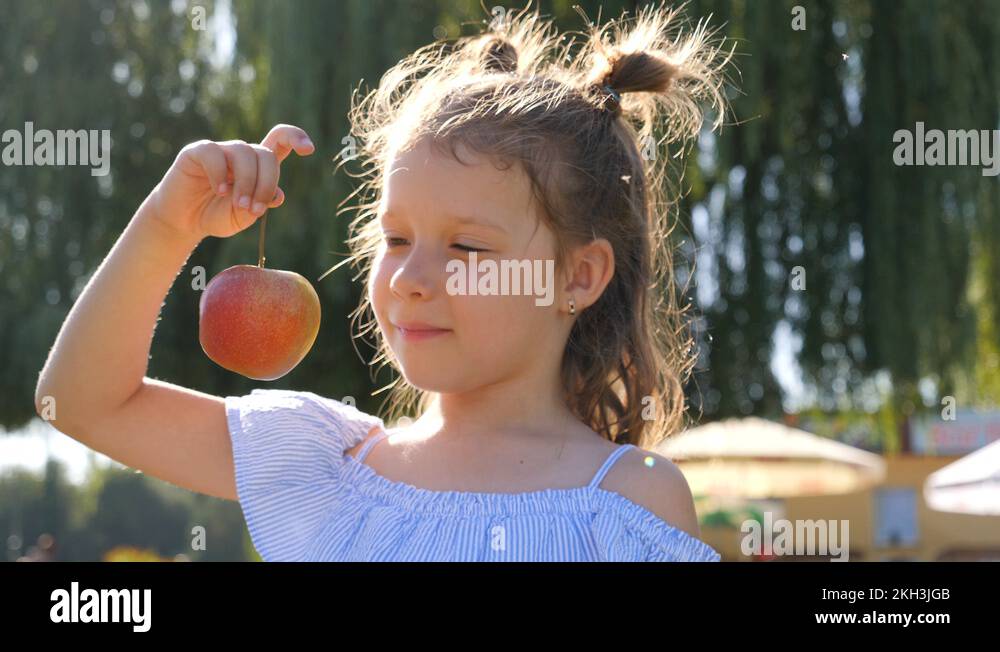 Cute kid girl fail with food accidentally drop an apple loses it while ...