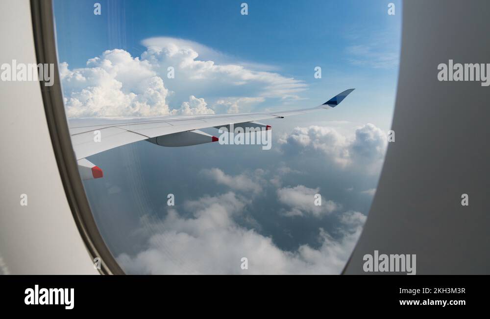 Hyperlapse view trough plane window of jet wing flying above the sea ...
