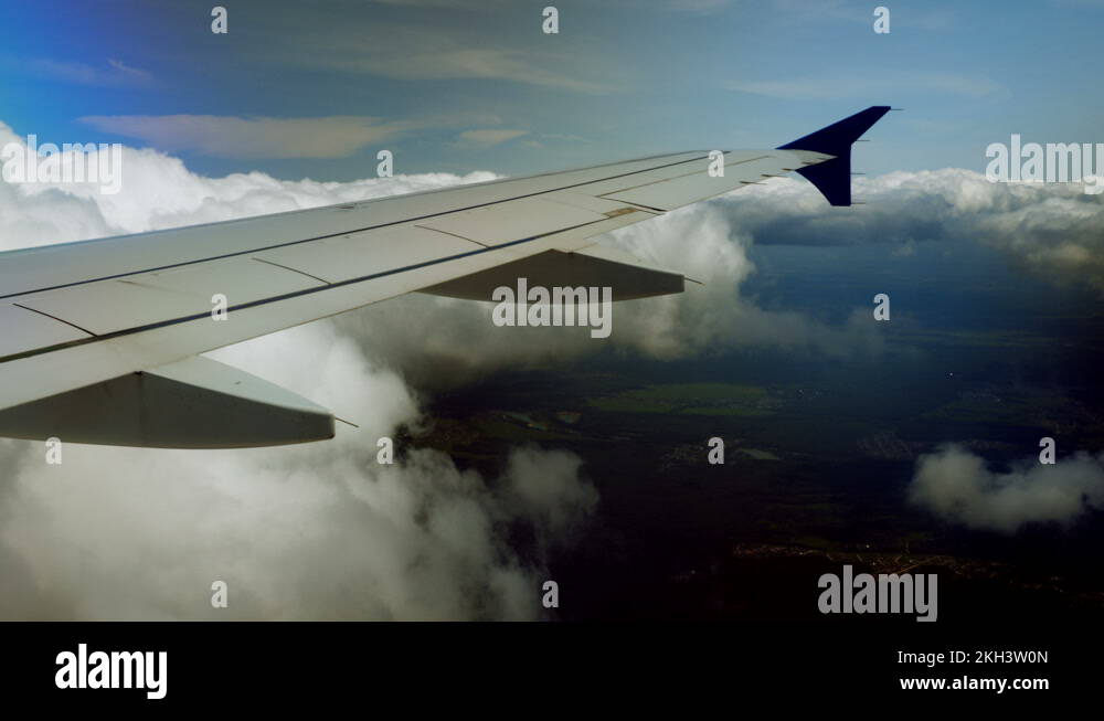 Aeroplane. View of airplane wing of aircraft flying above the clouds ...