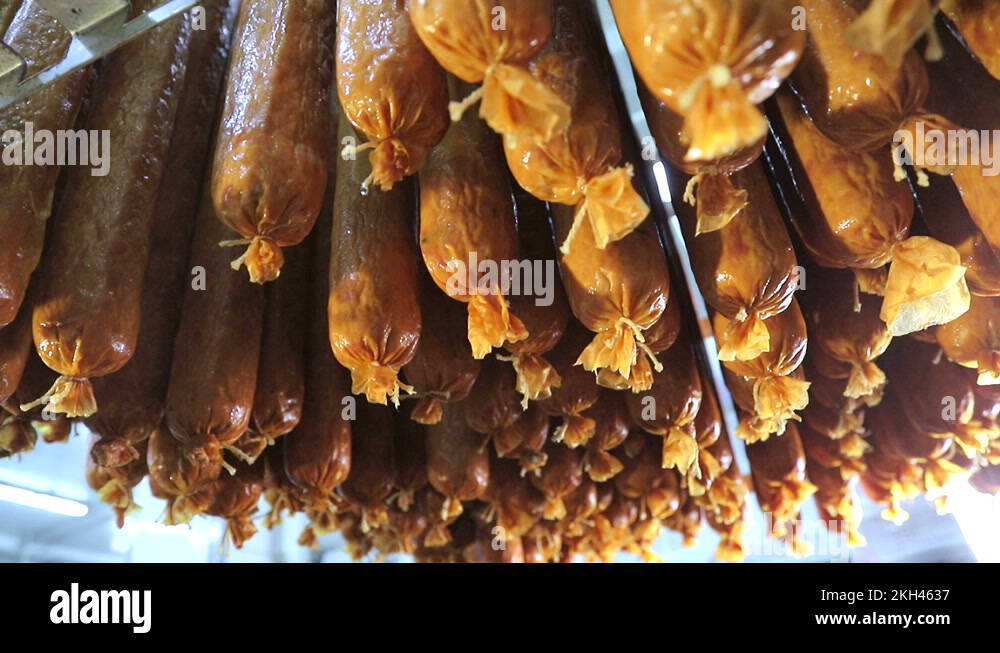 Batch of finished sausage stored on the shelves in the production. A ...