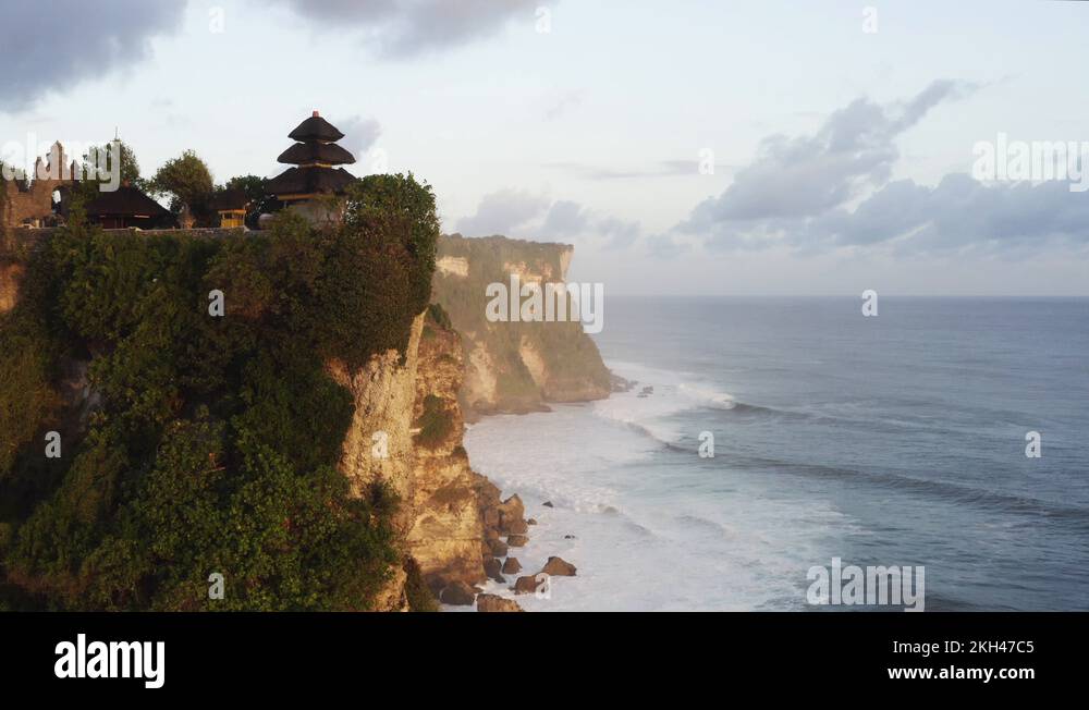 Aerial view of Uluwatu temple on the top of high cliff, calm ocean ...