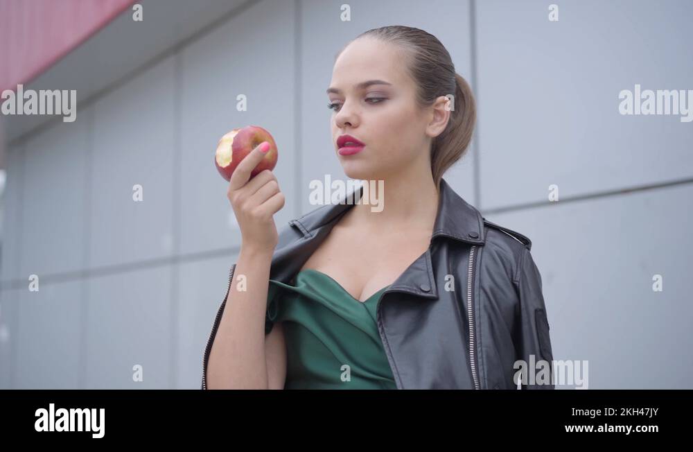 Portrait of a cute girl in an emerald evening dress and a leather ...
