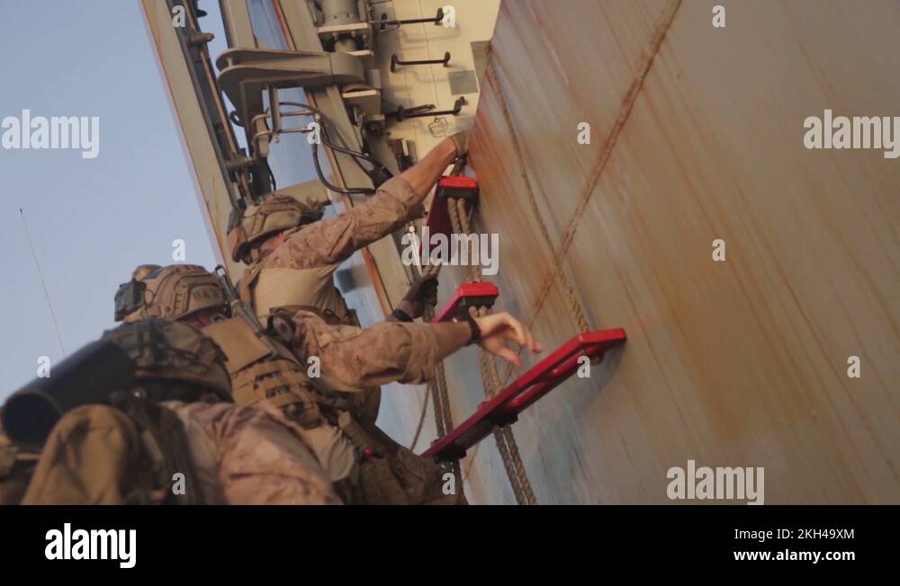 Marines using rope ladder to board USS John P Murtha for VBSS training ...