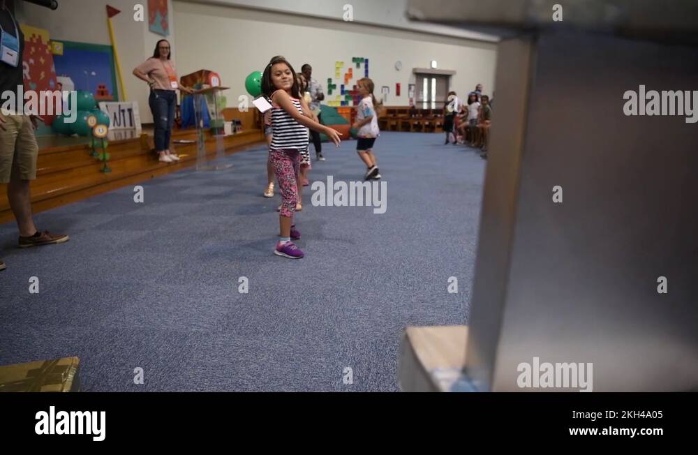 Child throwing ball and making boxes tumble at vacation bible school ...
