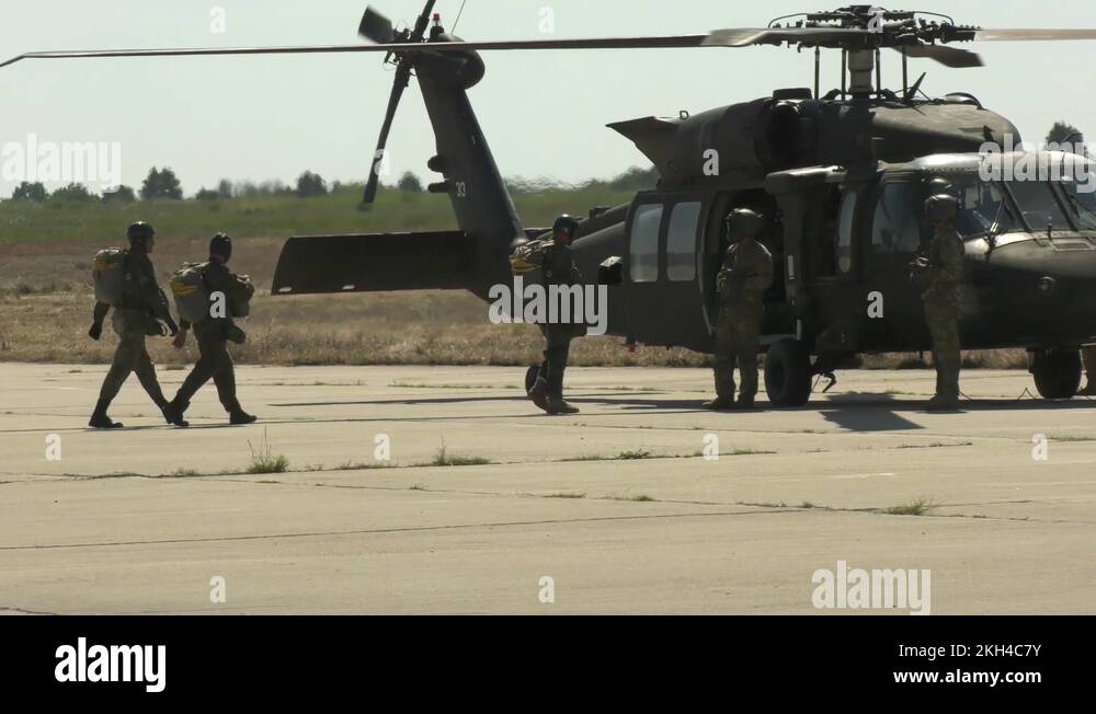 Military parachutists boarding UH-60 Black Hawk helicopter for static ...