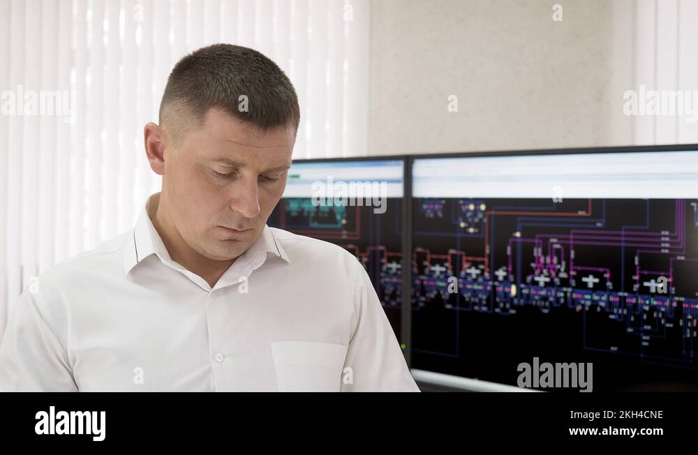 Man engineer working with documents and data monitors on thermal power station Stock Video ...