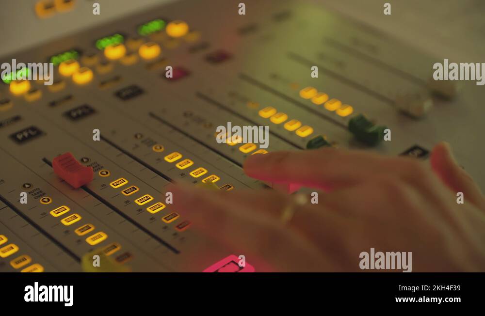 Professional audio mixing console with faders raising volume Stock ...