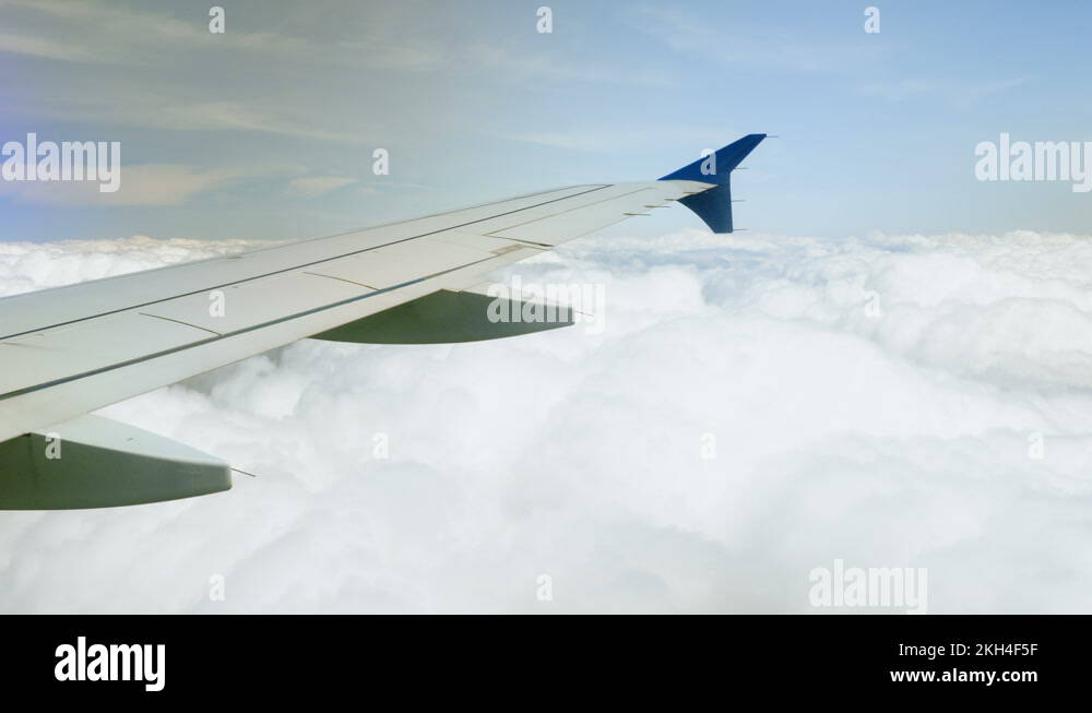 Aeroplane. View of airplane wing of aircraft flying above the clouds ...