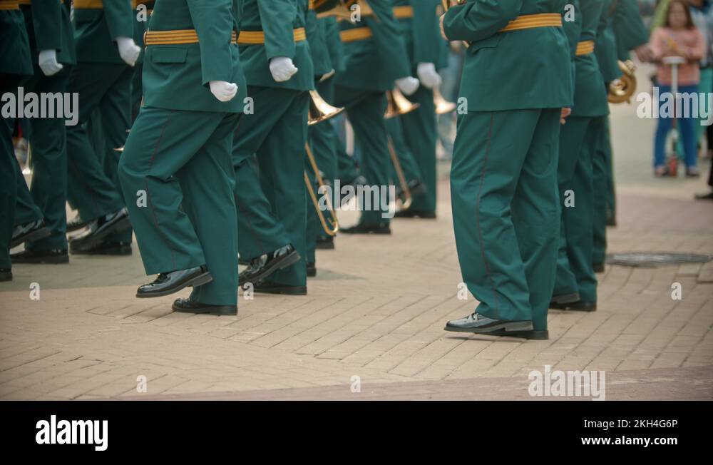 A wind instrument military parade - people in green costumes marching ...