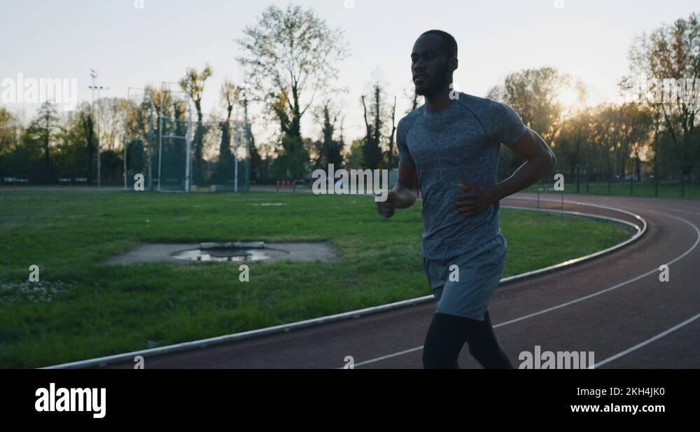 Slow motion of young african male athlete is running on race track in ...