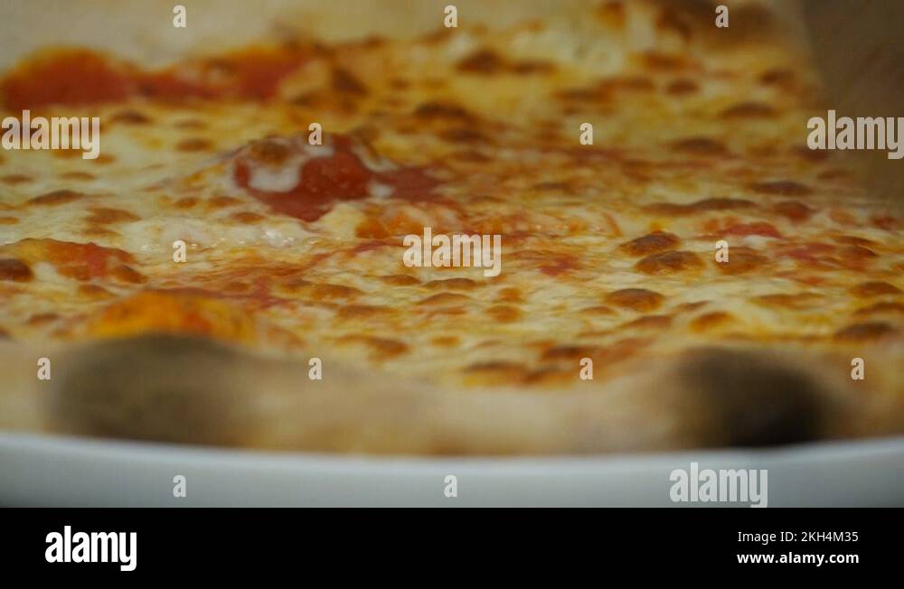 Cutting cooked pizza with round pizza knife closeup. Inside Italian ...