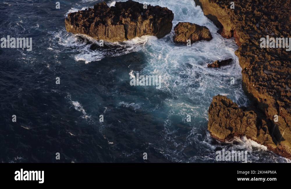 Breathtaking blue ocean waves breaking at cliffs with slpashings and ...