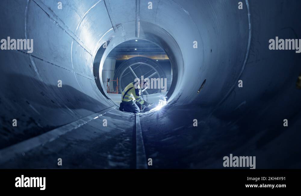 Professional Heavy Industry Welder Works Inside Pipe Wears Helmet ...