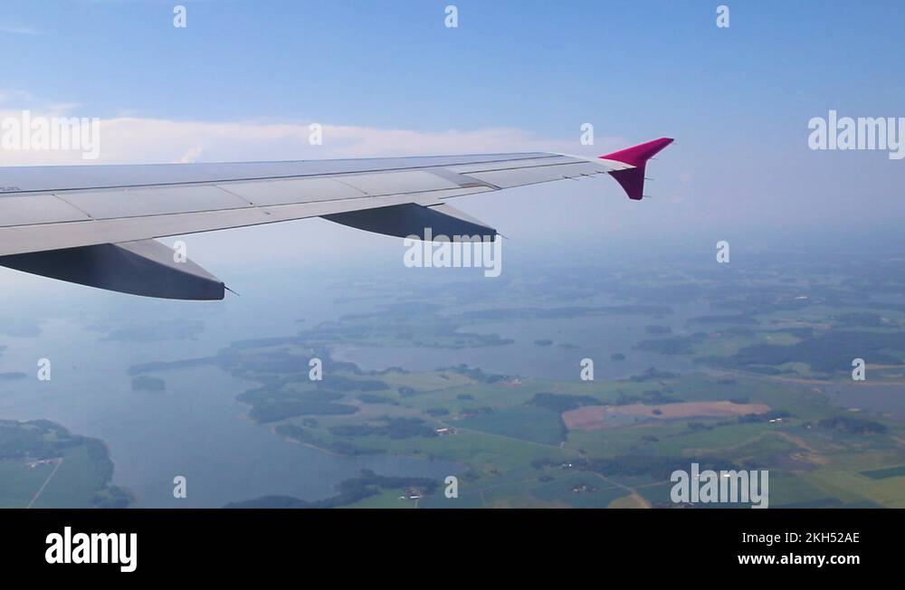 Airplane flight. Wing of an airplane flying above the clouds with ...