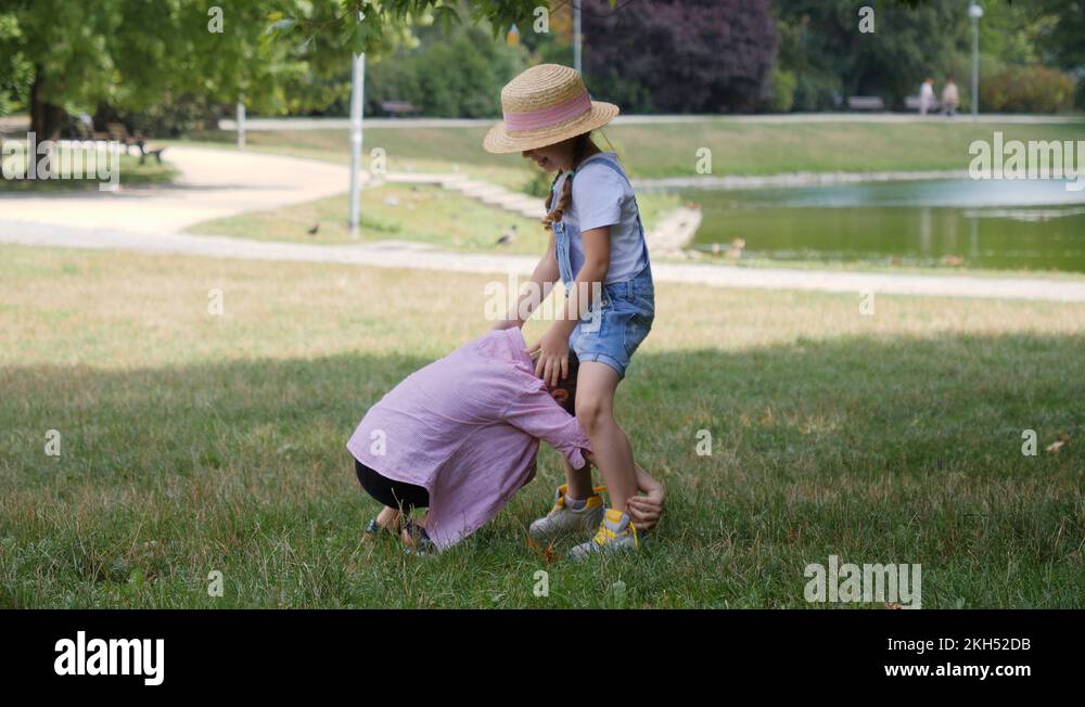 Funny children fail play together on park grass dancing spinning ...