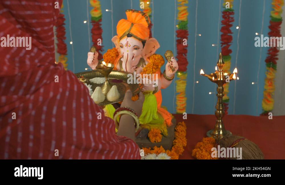 Overhead shot of an Indian female worshipping Lord Ganesha on Ganesh ...