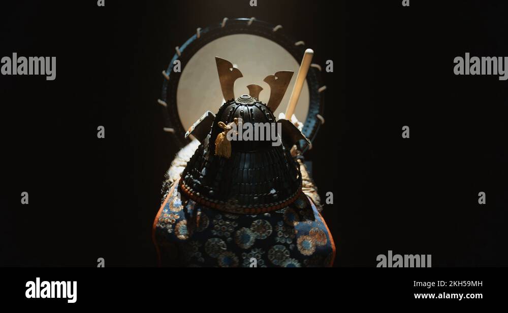 Japanese man in historical samurai costume playing on taiko drum with ...
