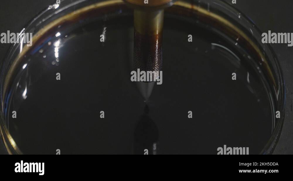 Magnet is dipped in liquid metal and futuristic graphics appear in ...