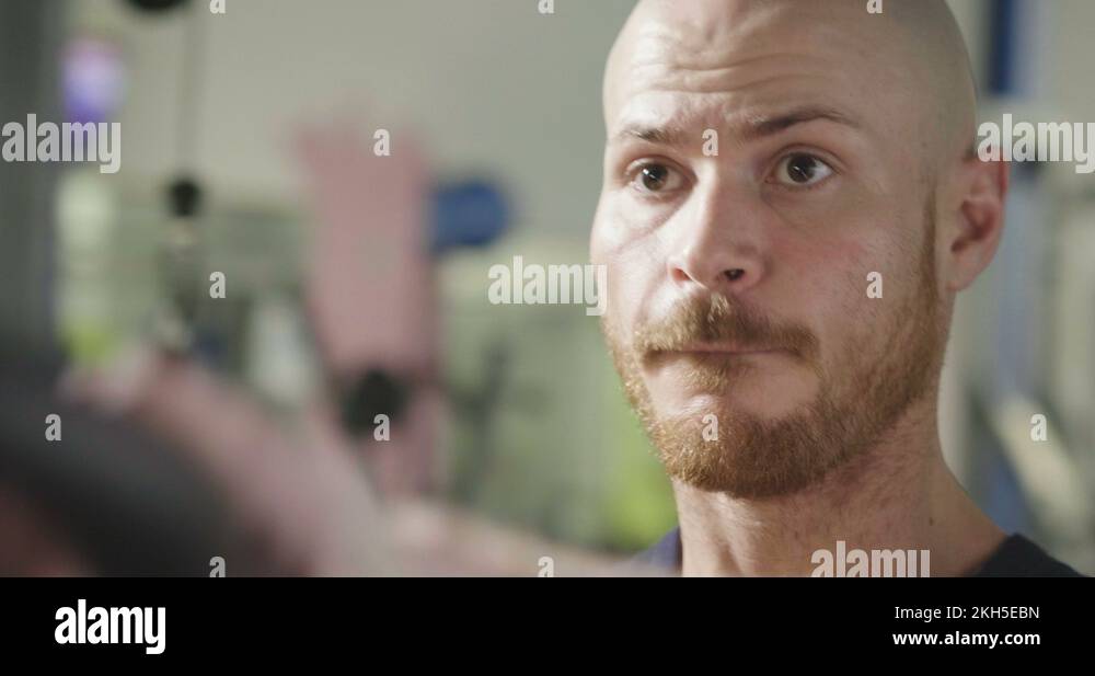 A professional young kickboxer with fit body is making a routine ...