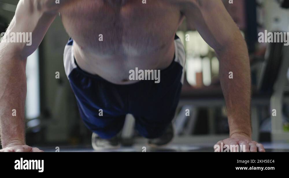 A professional young kickboxer with fit body is making a routine ...