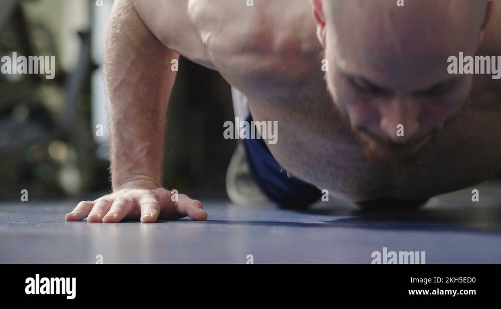 A professional young kickboxer with fit body is making a routine ...