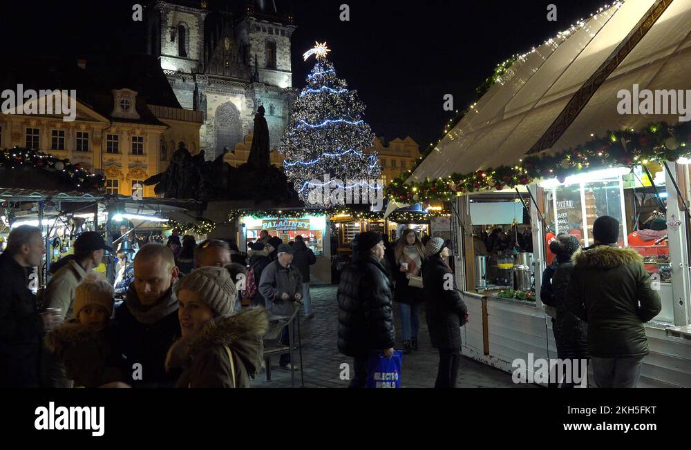 People wait in line in front of a store at a crowded Christmas market ...