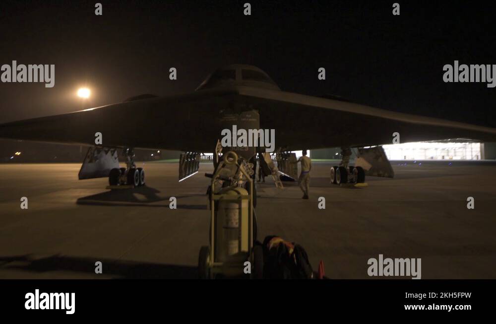 Aircraft marshaller preparing to climb steps into B-2 Spirit stealth ...