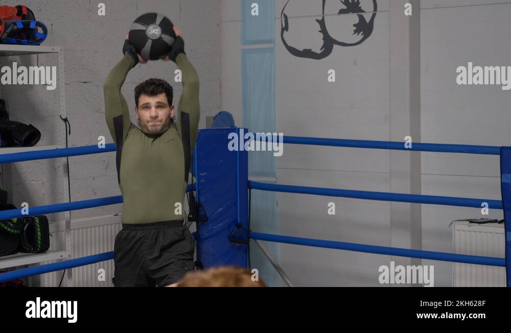 Two boxer man throwing ball to each other on warming training on ring ...