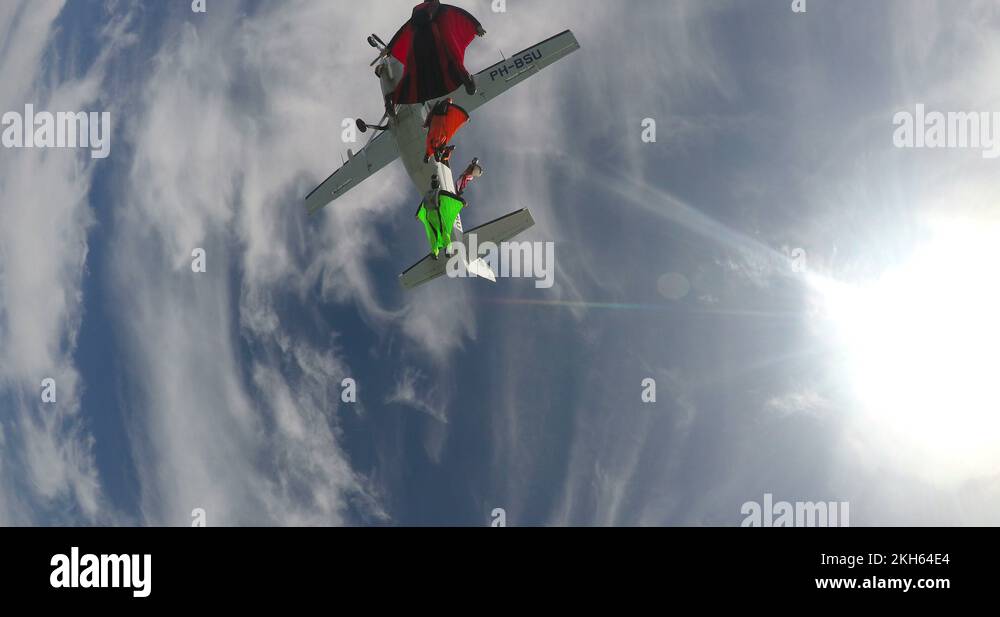 Men with a woolen suit knock out of a plane in the void and fly in the ...