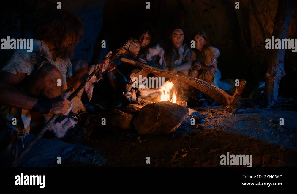 Neanderthal or Homo Sapiens Family Cooking Animal Meat over Bonfire and ...