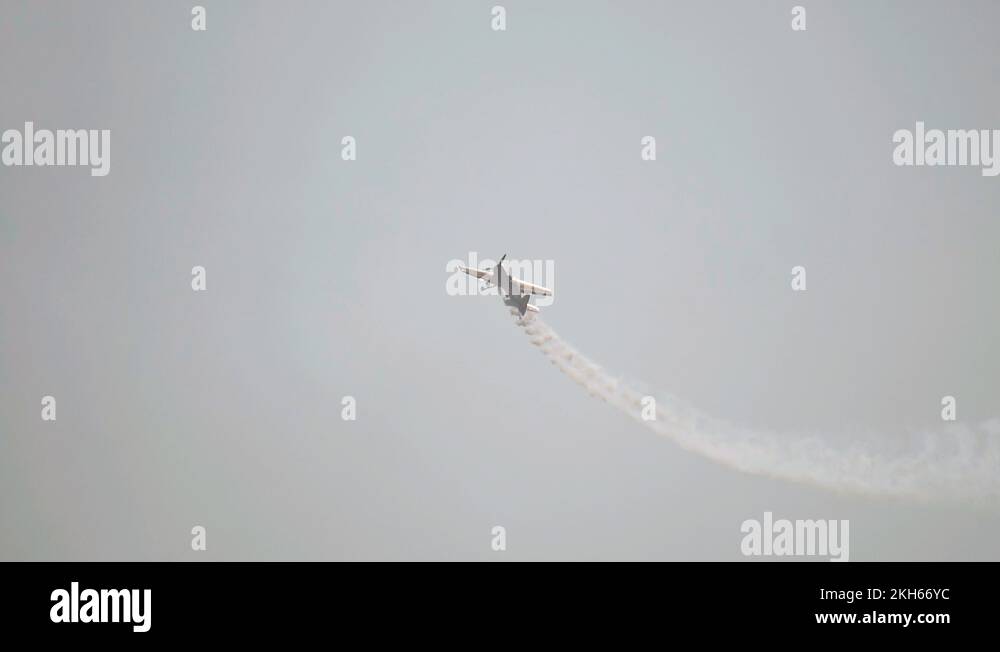 A single-engine plane soars into the sky leaving a trail in the sky ... A single-engine plane soars into the sky leaving a trail in the sky ...