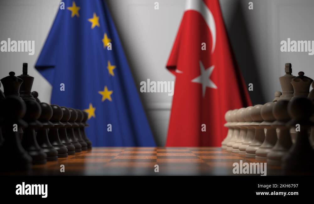 Flags of the EU and Turkey behind chess board. The first pawn moves in ...