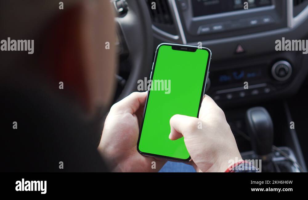 The guy in the car holding phone with green screen and poking ...