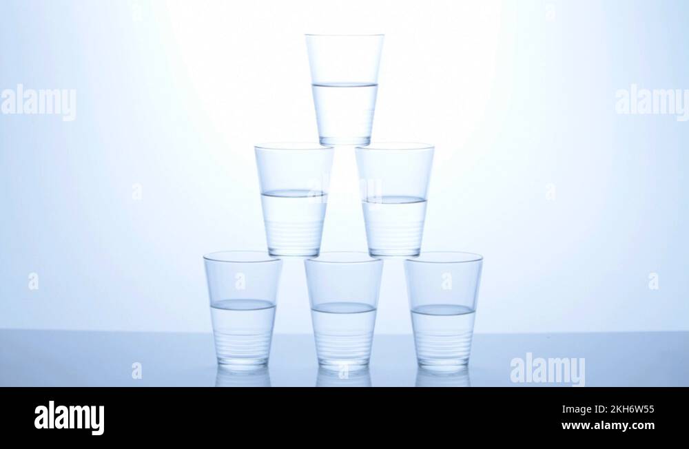 Pyramid of water glasses, water is overflowing Stock Video Footage - Alamy