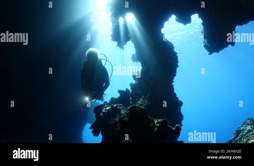 cave diving underwater scuba divers exploring cave dive caverns tunnels ...