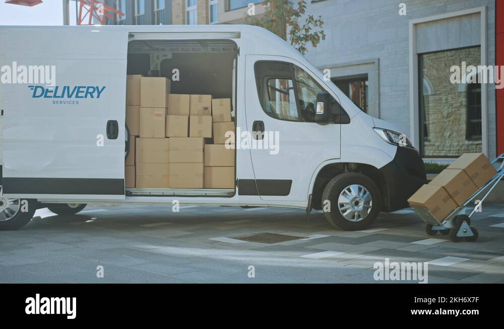 Delivery Man Uses Hand Truck Trolley Full of Boxes and Packages, Loads ...