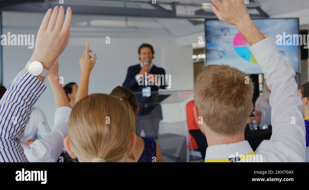 Businessman inviting questions from the audience at a business ...