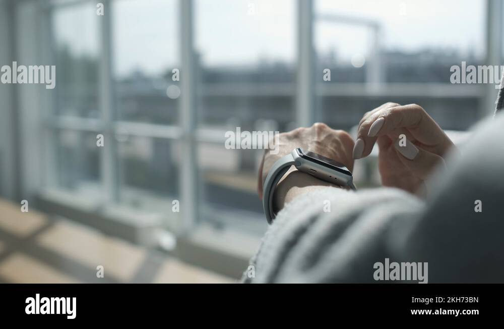 Woman making gestures on a wearable smartwatch computer device, smart ...