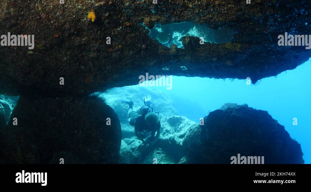 scuba diver exploring the caves reefs rocks underwater slow Stock Video ...