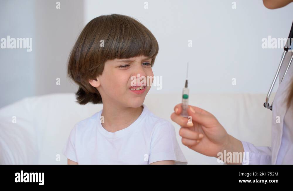 Portrait of child cute little boy afraid of injection. Doctor nurse ...